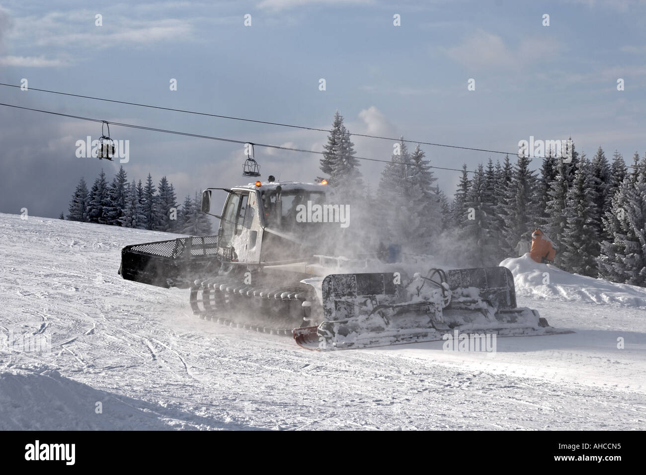 Snow plough or dameuse piste basher in snow ski resort area of Morzine ...