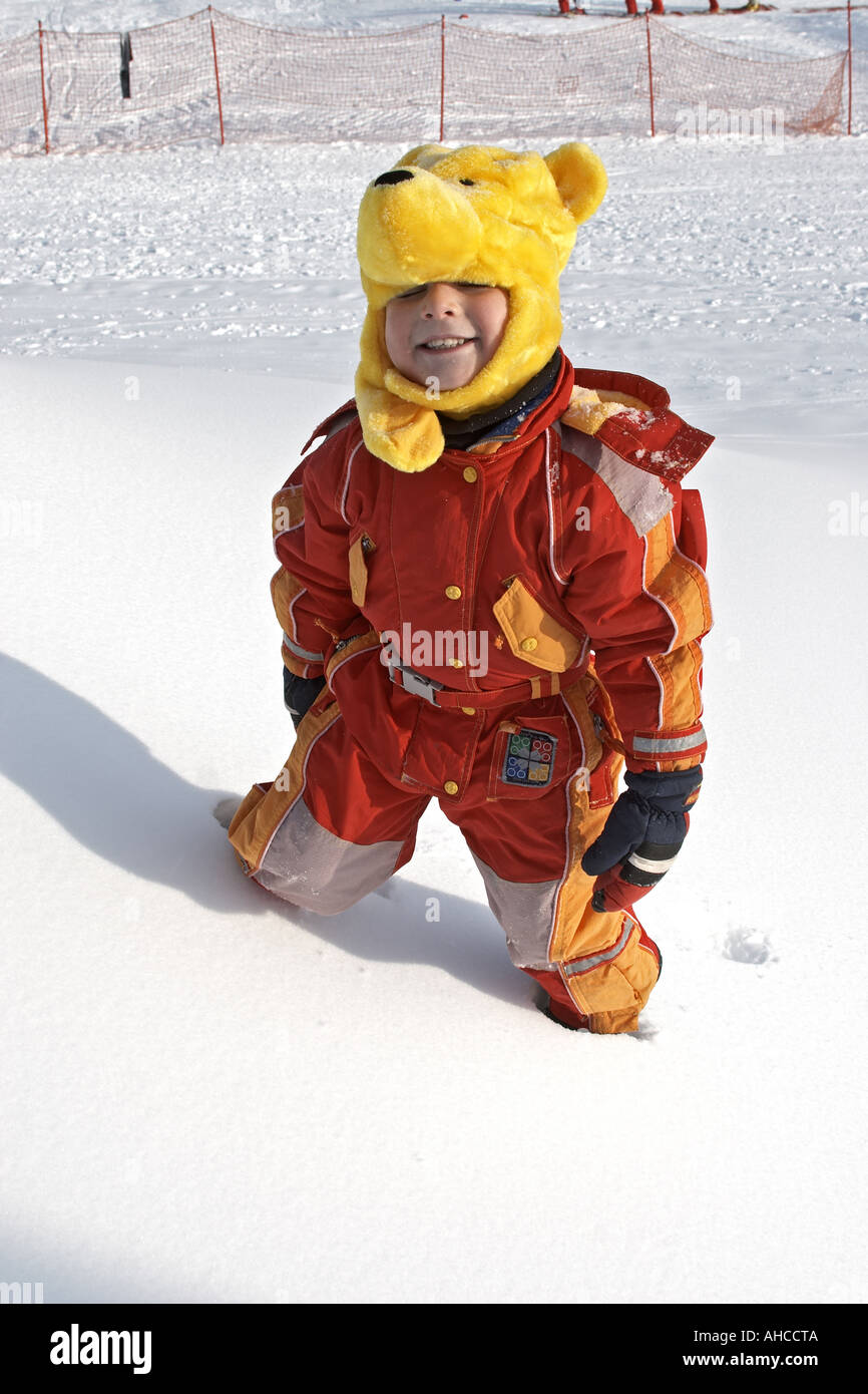 Young boy child in amusing animal hat climbing a mound Stock Photo - Alamy
