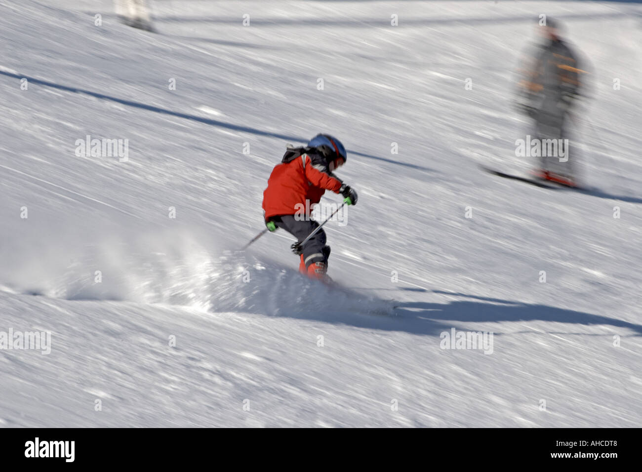 Man person skiing fast with snow spray Stock Photo - Alamy