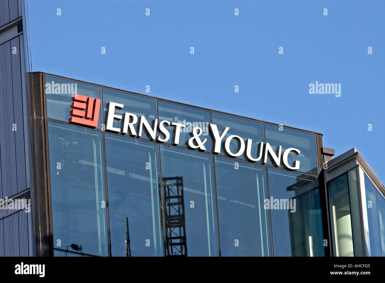 Ernst and Young sign on 1 More London Place building with blue sky and ...