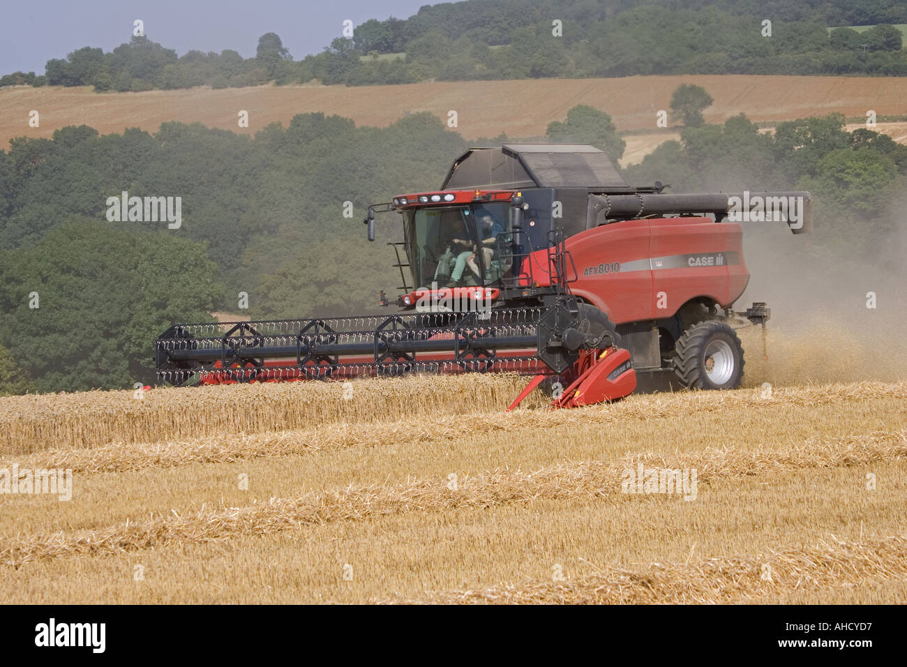 Red combine harvester working in Cotswolds near Winchcombe UK Stock ...