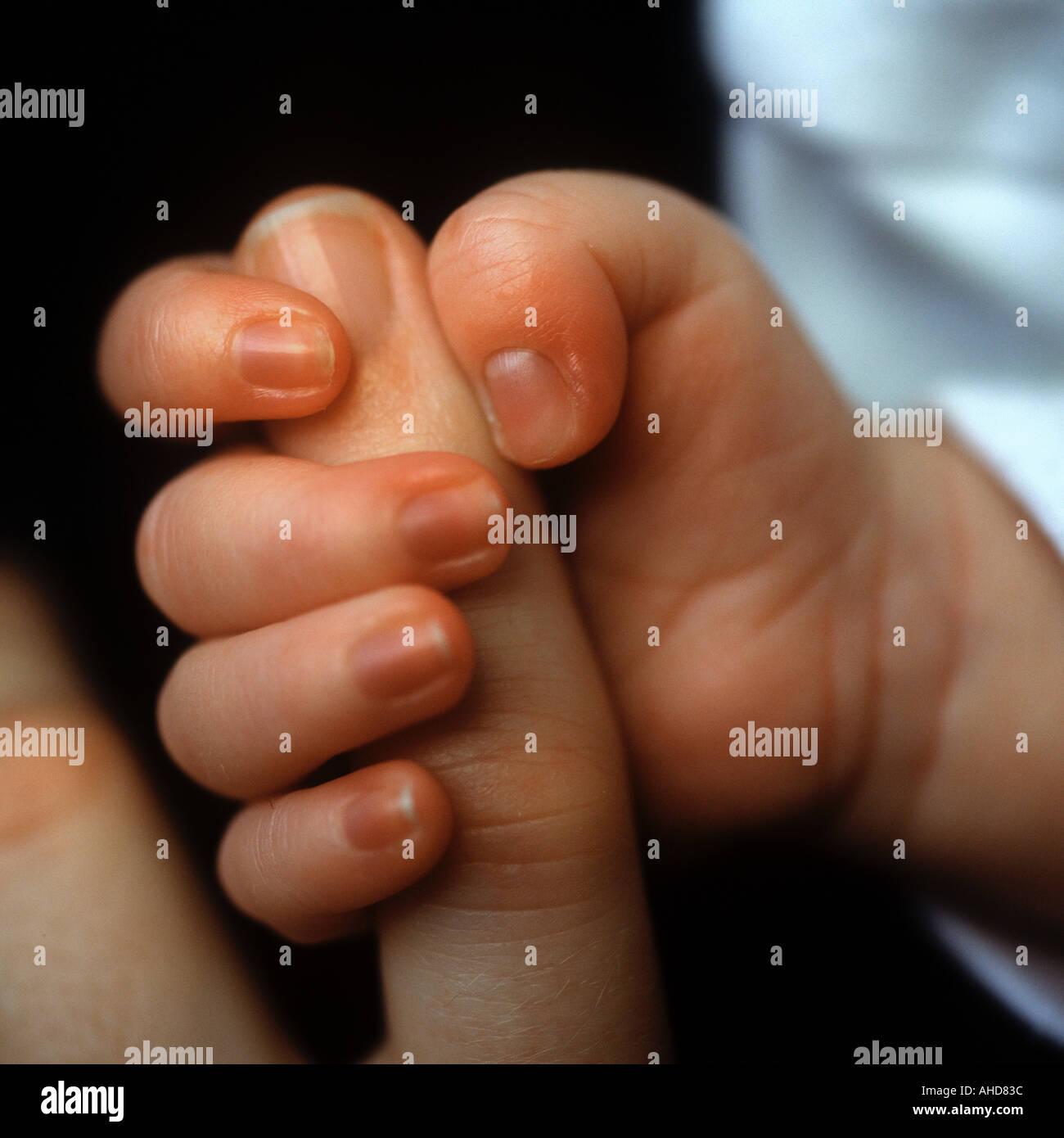 Baby holding mothers index finger hi-res stock photography and images ...