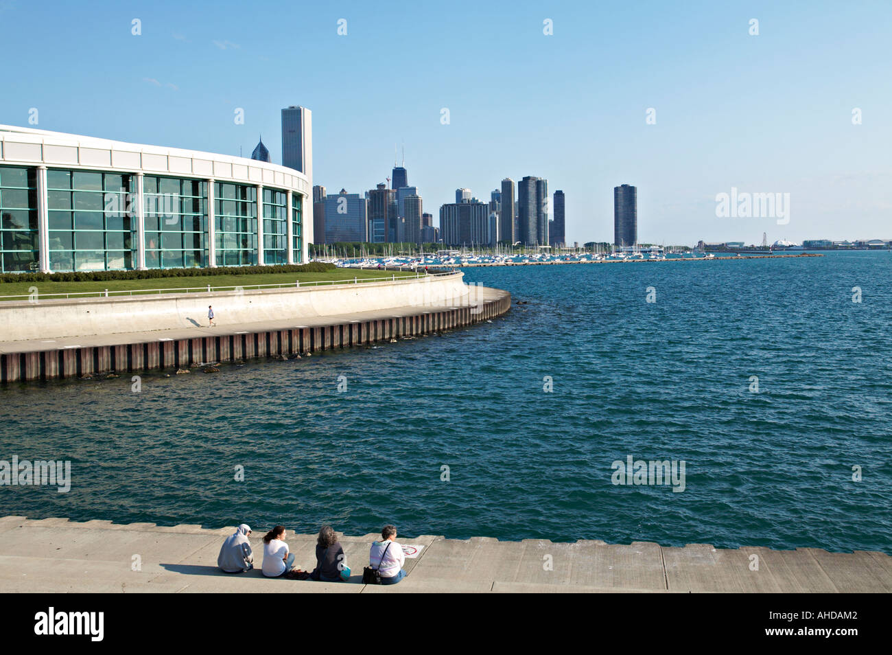ILLINOIS Chicago People sit on concrete steps near exterior of Shedd ...