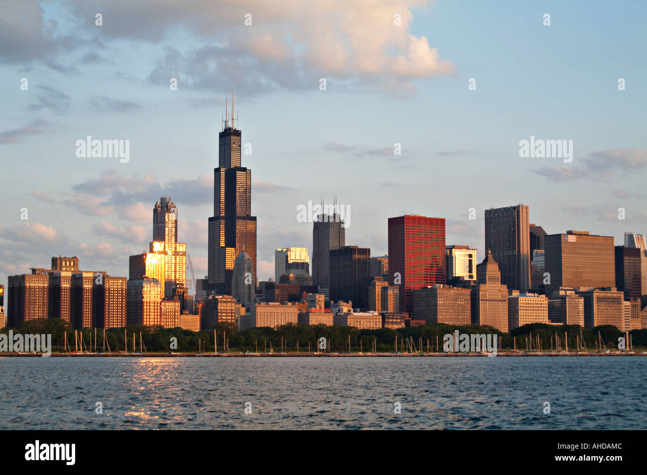ILLINOIS Chicago City skyline in early morning at sunrise sun reflected ...