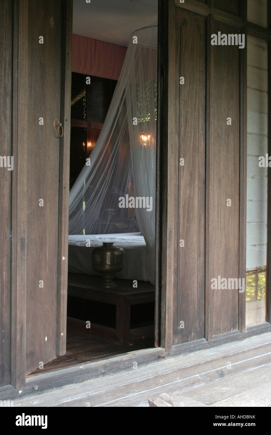 View of a bedroom from half closed door of a traditional Malay house at ...