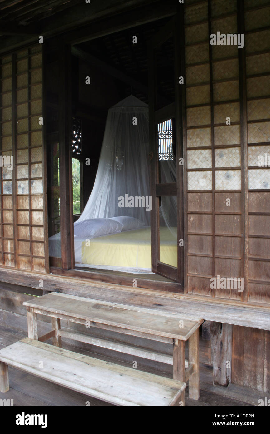 View of a bedroom from half closed door of a traditional Malay house in ...