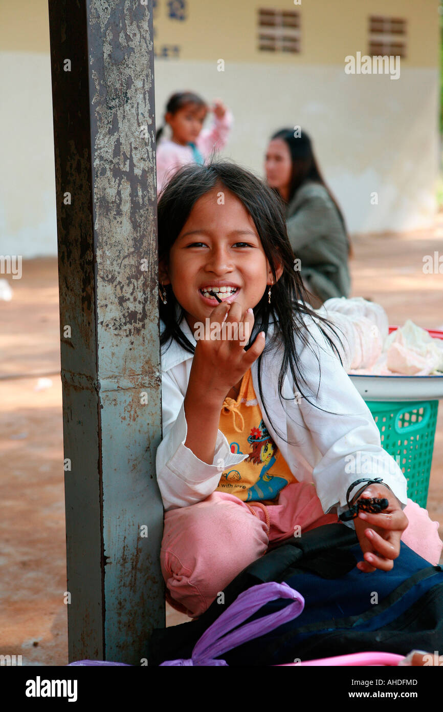 Khmer girl eating tarantula spiders at Skuon, (Spiderville) on NH6 ...