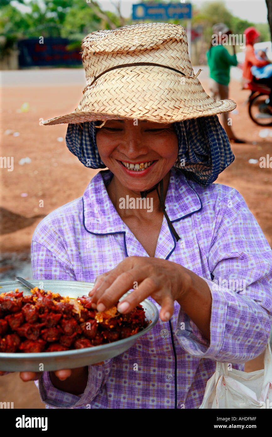 Khmer woman selling tarantula spiders at Skuon, (Spiderville), on NH6 ...