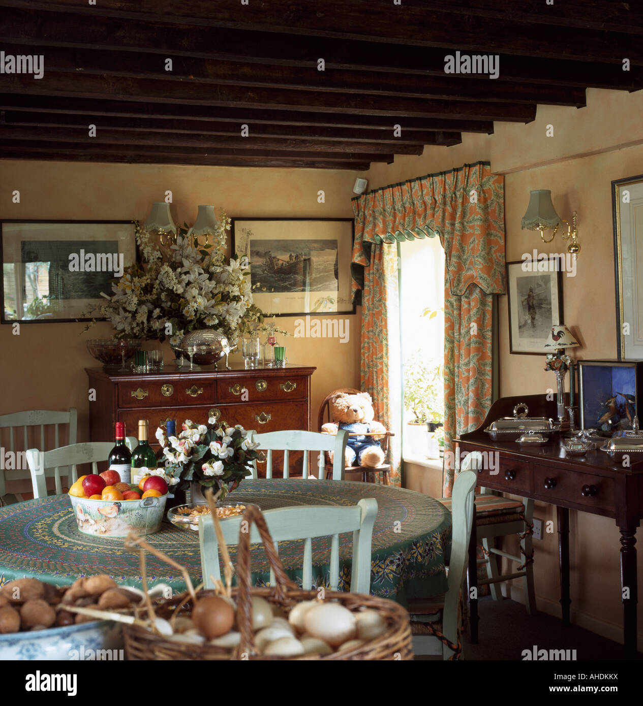 Painted pastel blue table and chairs in beamed cottage dining room ...