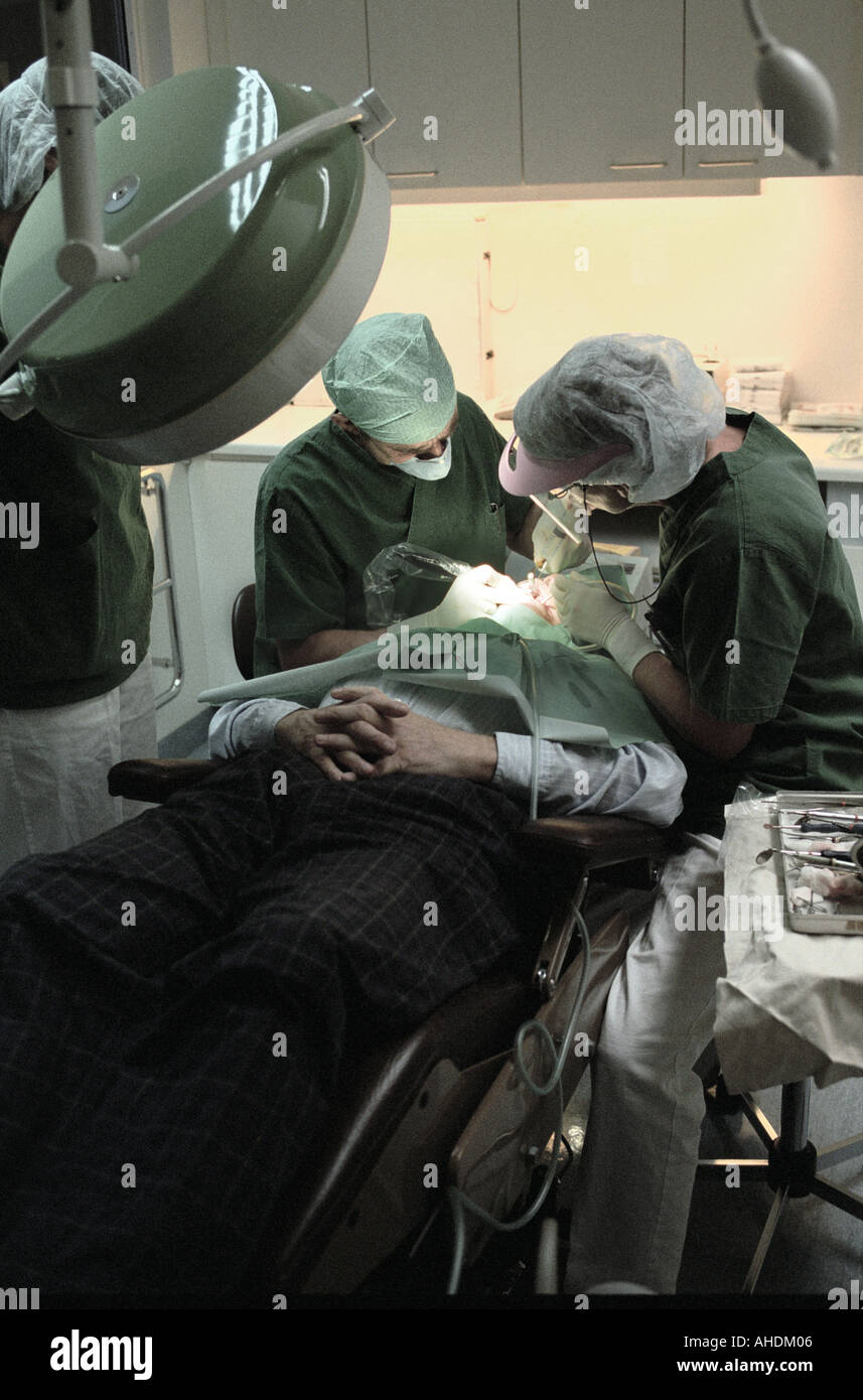 Sweden Stockholm A dentist and a nurse in surgery putting in titanium ...