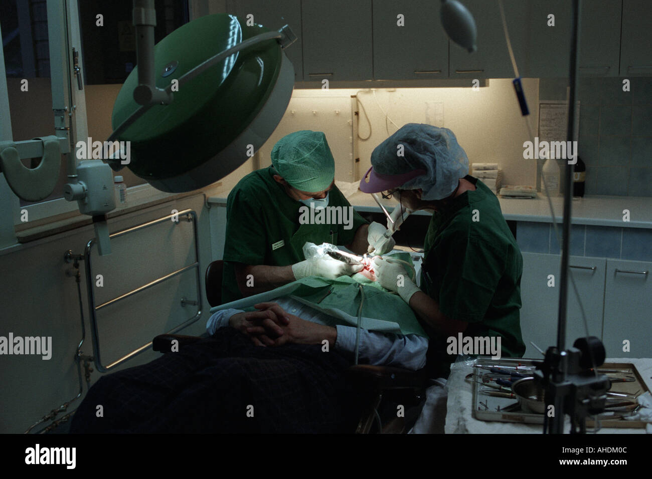 Sweden Stockholm A dentist and a nurse in surgery putting in titanium ...
