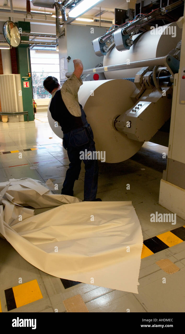 Changing paper rolls in a printing press Stock Photo - Alamy