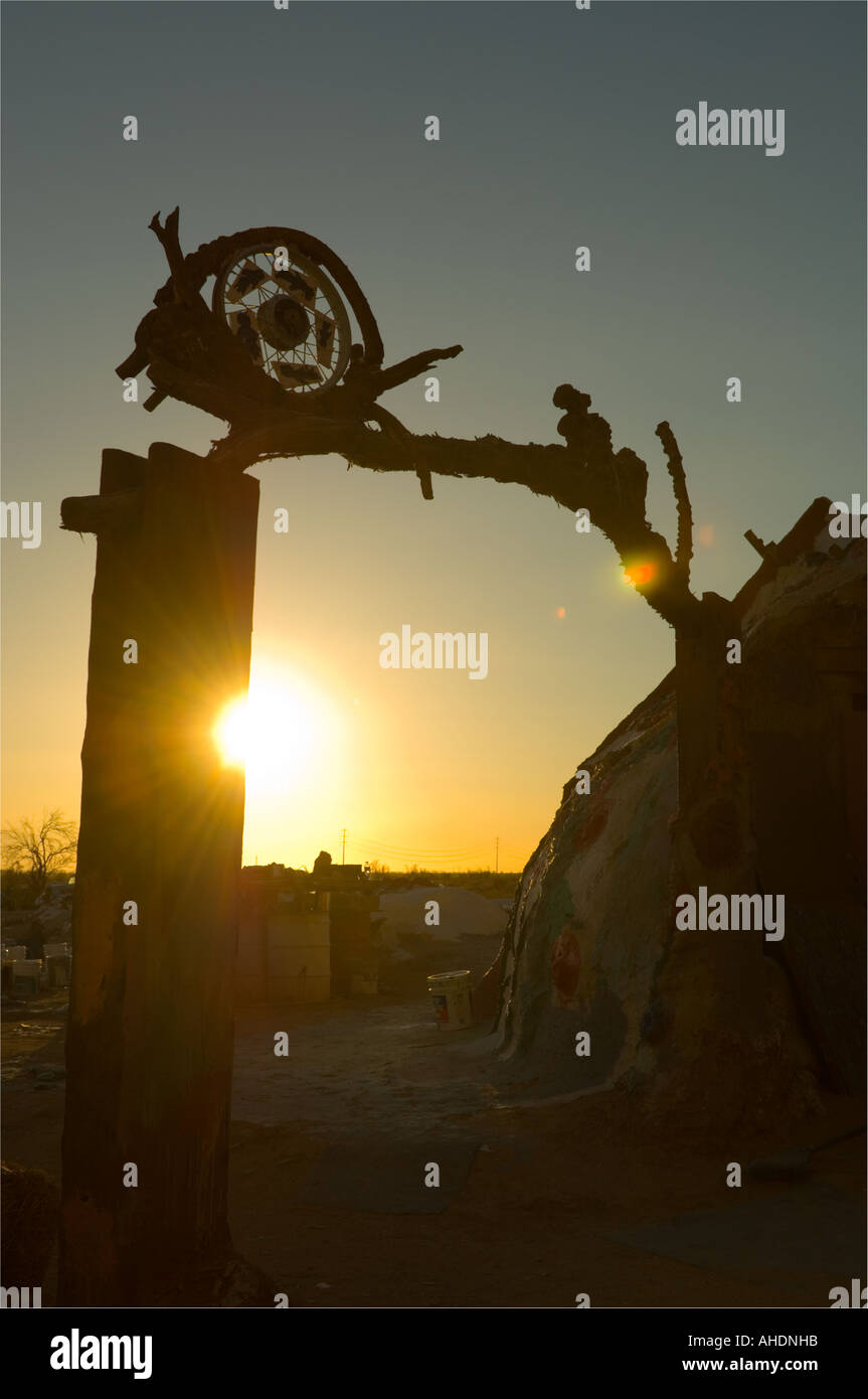 The sun sets behind a gate at Salvation Mountain Niland California ...