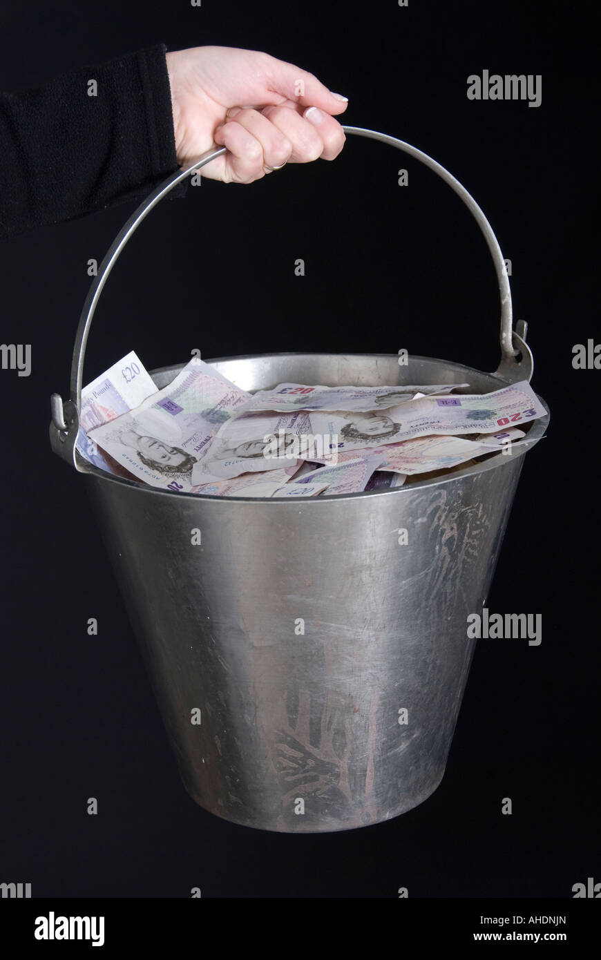 metal bucket full of 20 notes Stock Photo - Alamy