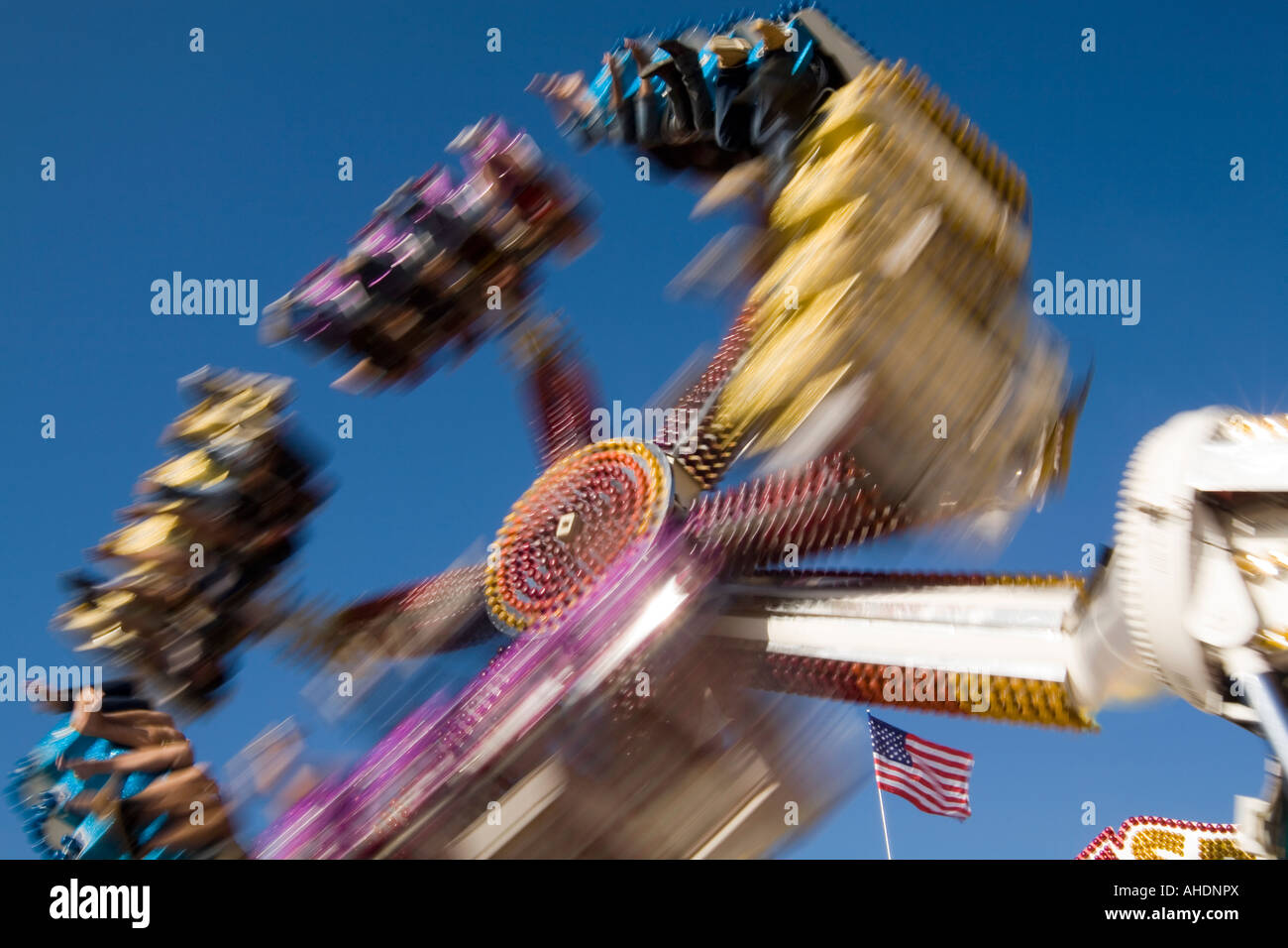 A colorful and exciting ride at a county fair, spinning and dipping ...