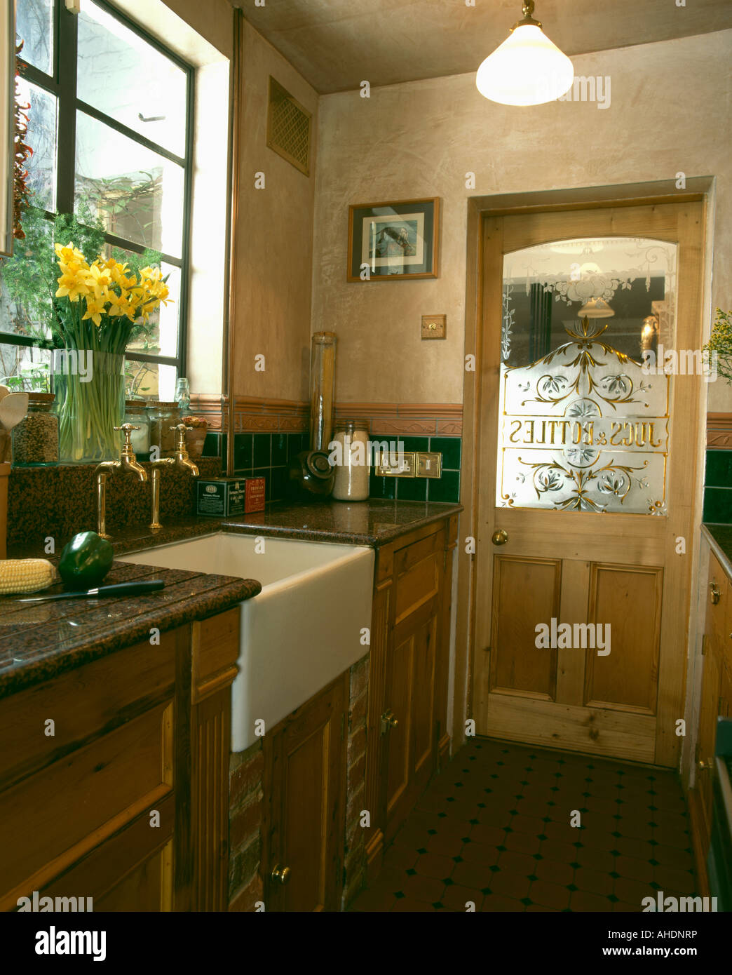 Engraved glass panel in door of kitchen with white ceramic sink Stock ...
