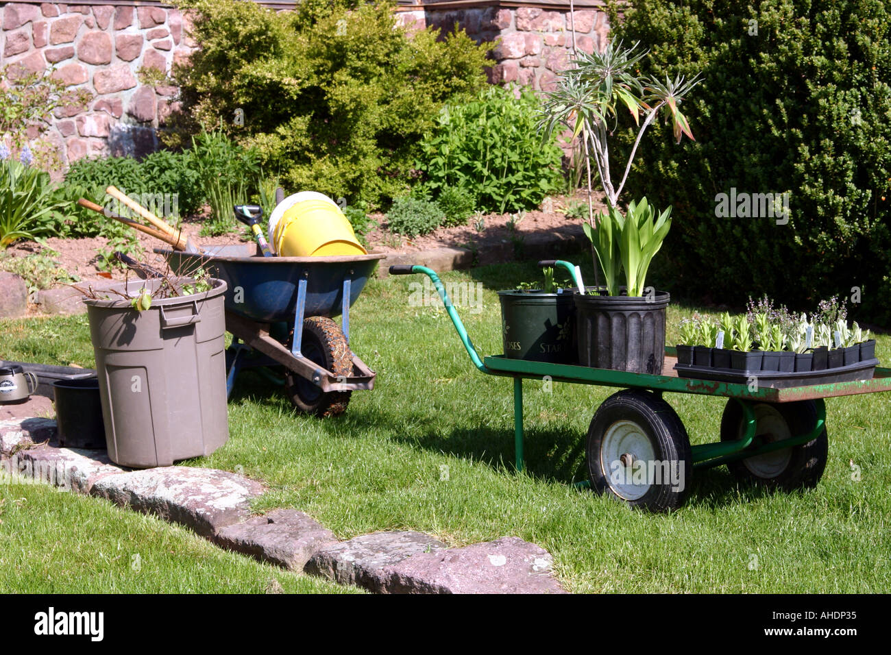 A wheelbarrow and a garden cart Stock Photo - Alamy