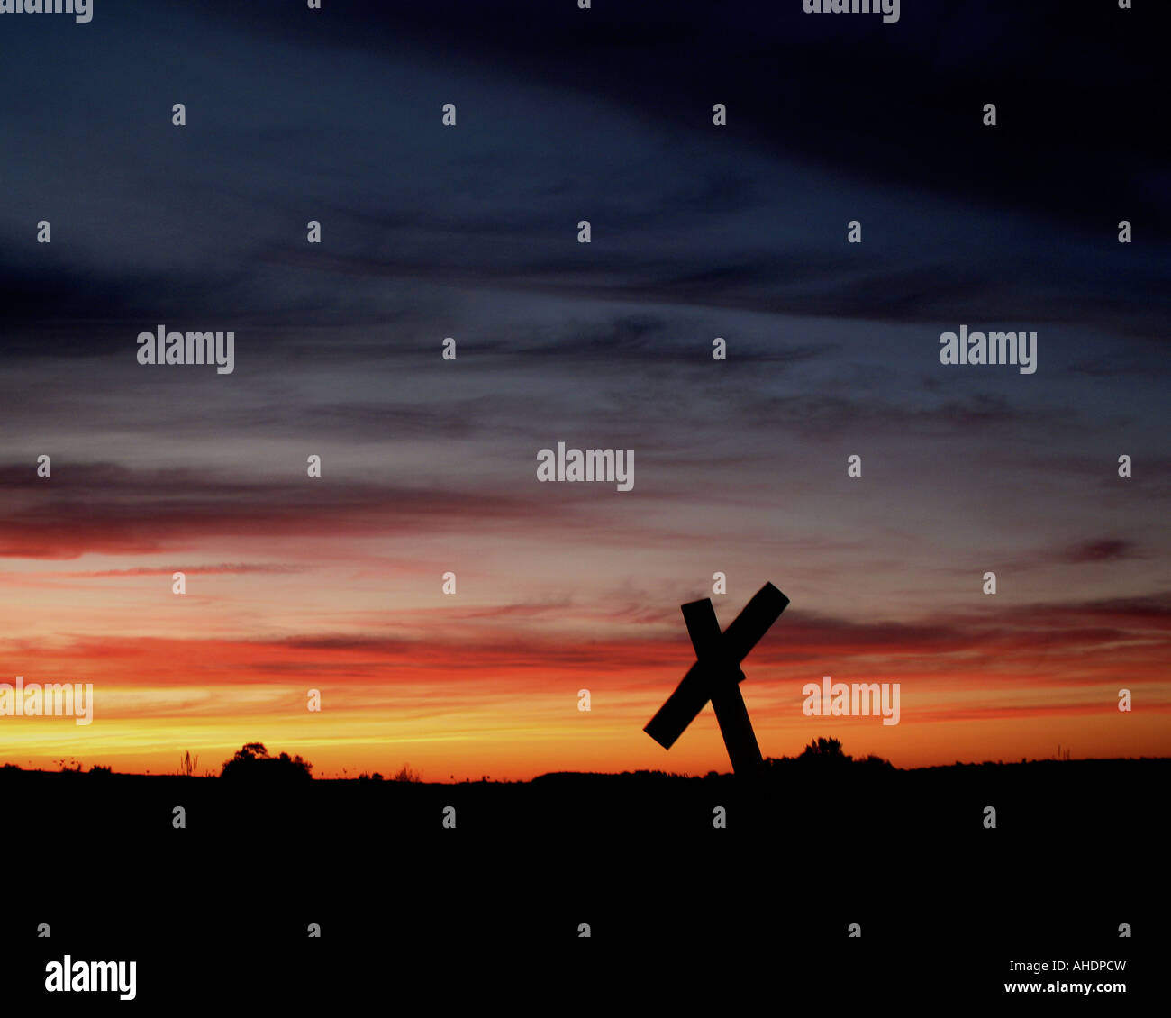 A lone cross in the sunset Stock Photo - Alamy