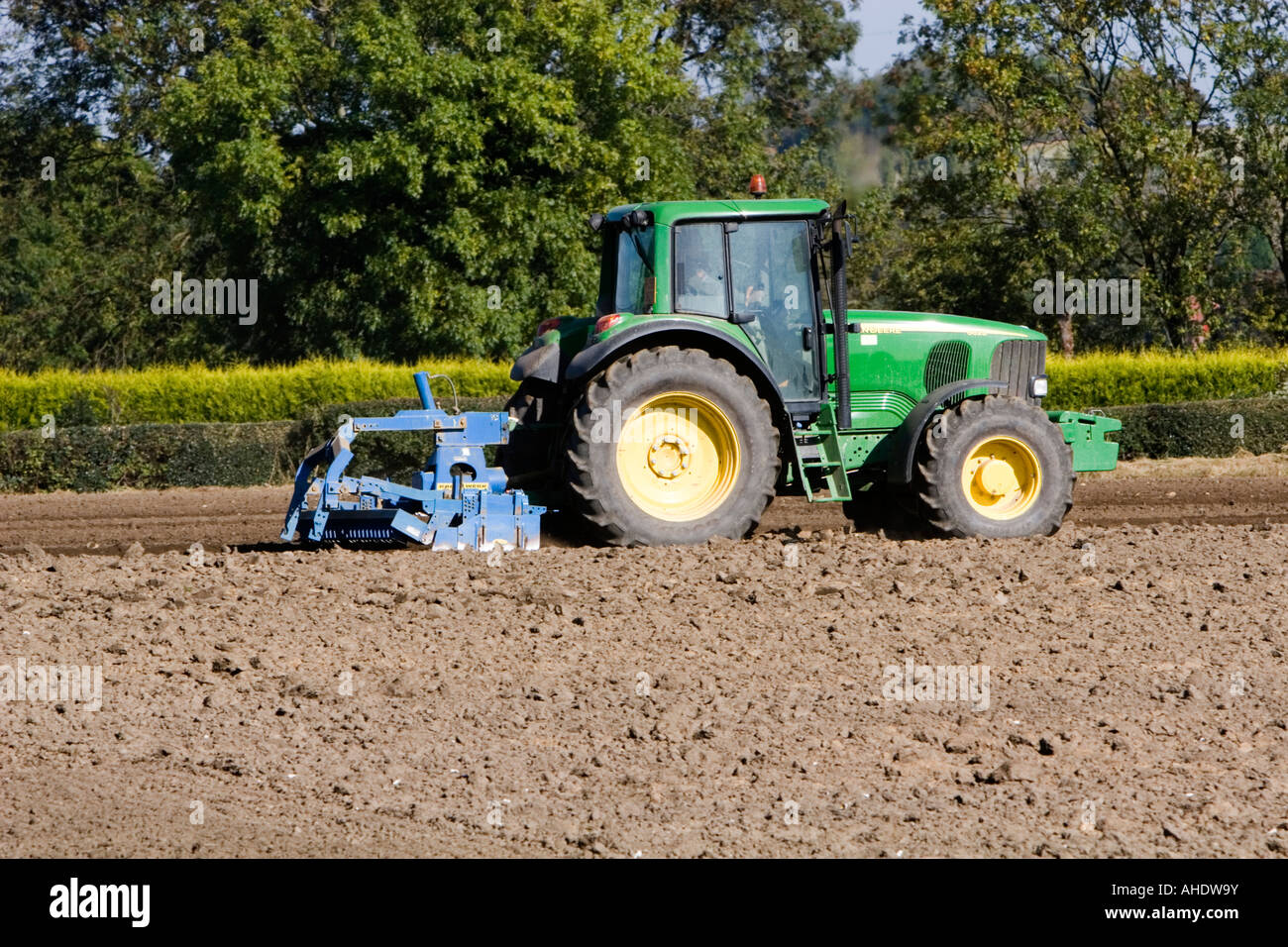 Tractor cultivating October Stock Photo - Alamy