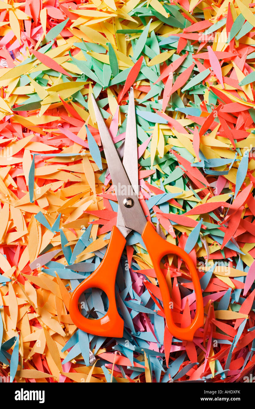 Scissors on pile of shredded paper Stock Photo - Alamy