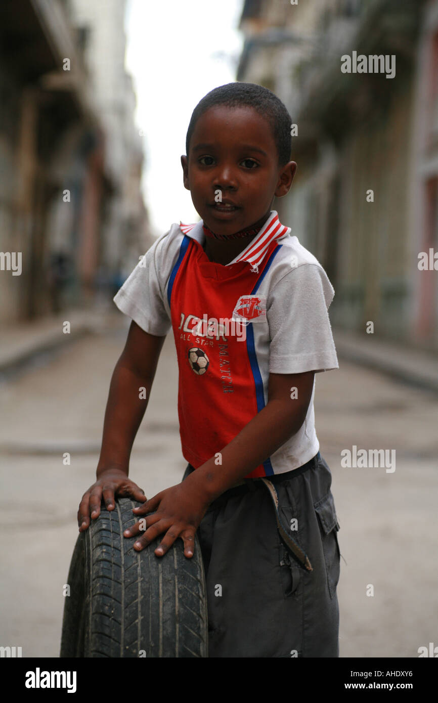 La Habana Cuba a young boy playing with an old tyre Stock Photo - Alamy