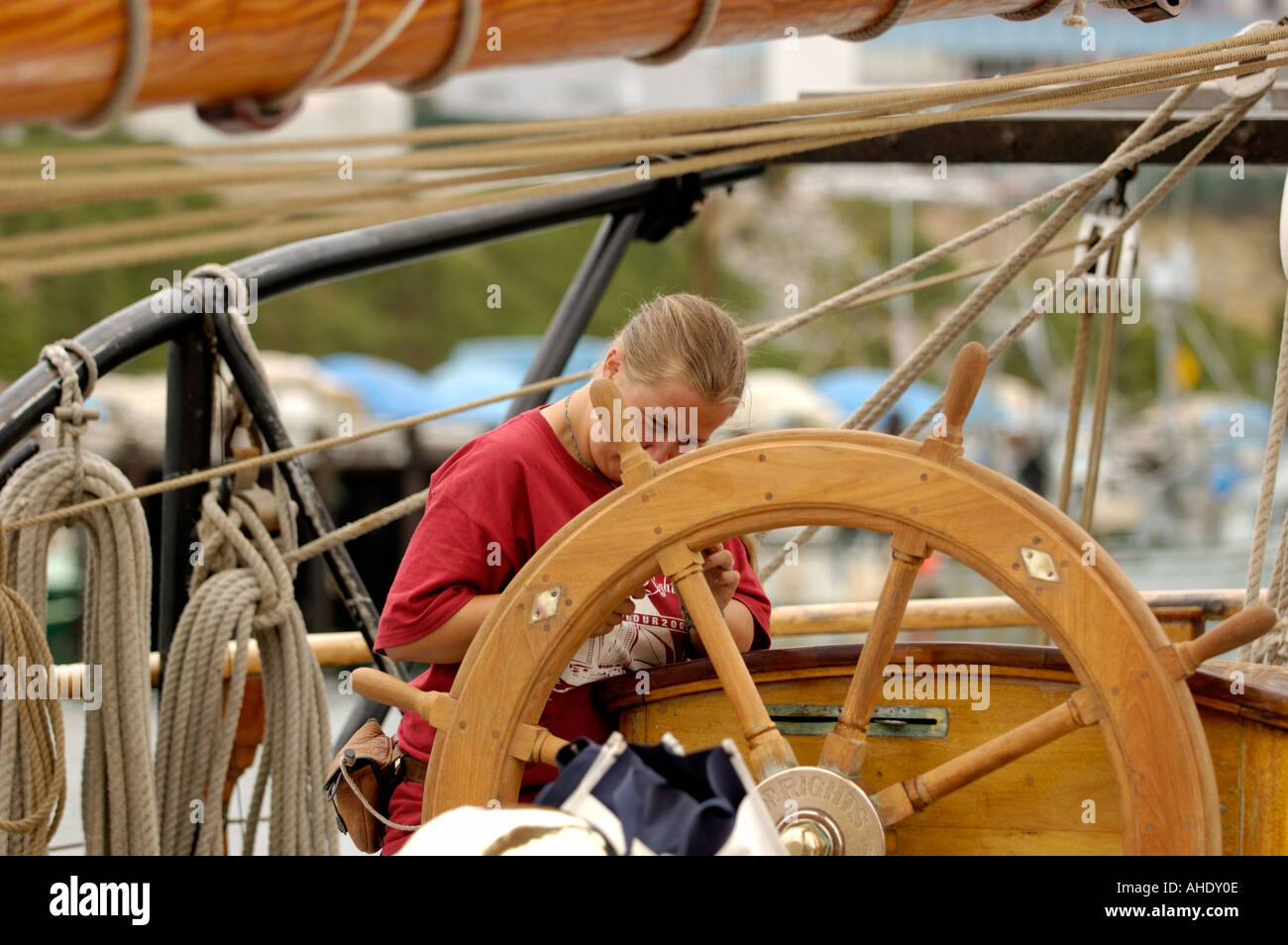 Sailor cleaning the steering wheel aboard tallship operated as a ...