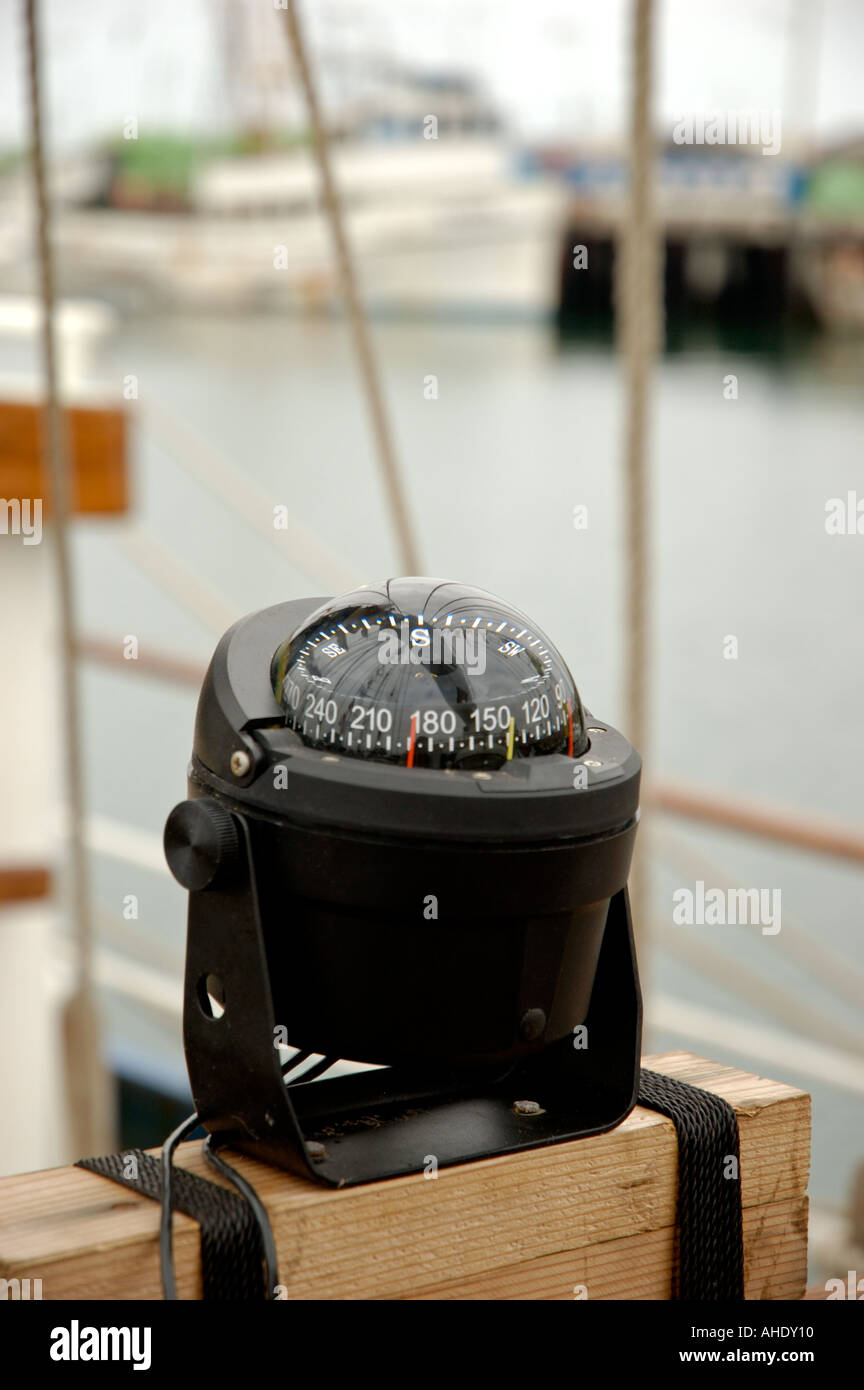 Modern compass on boat s helm Stock Photo - Alamy