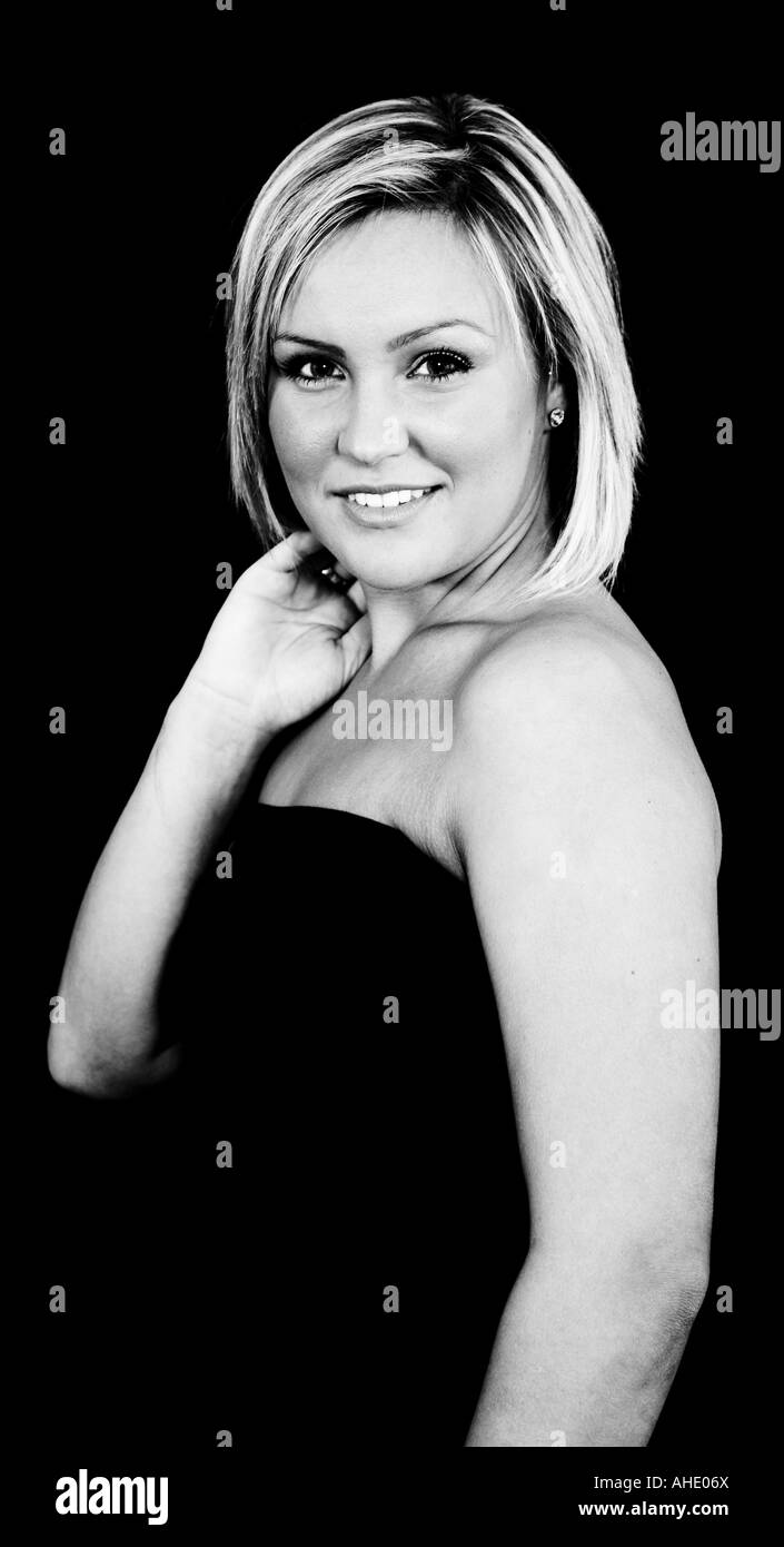 Blonde girl desaturated on black background, high contrast. Model ...