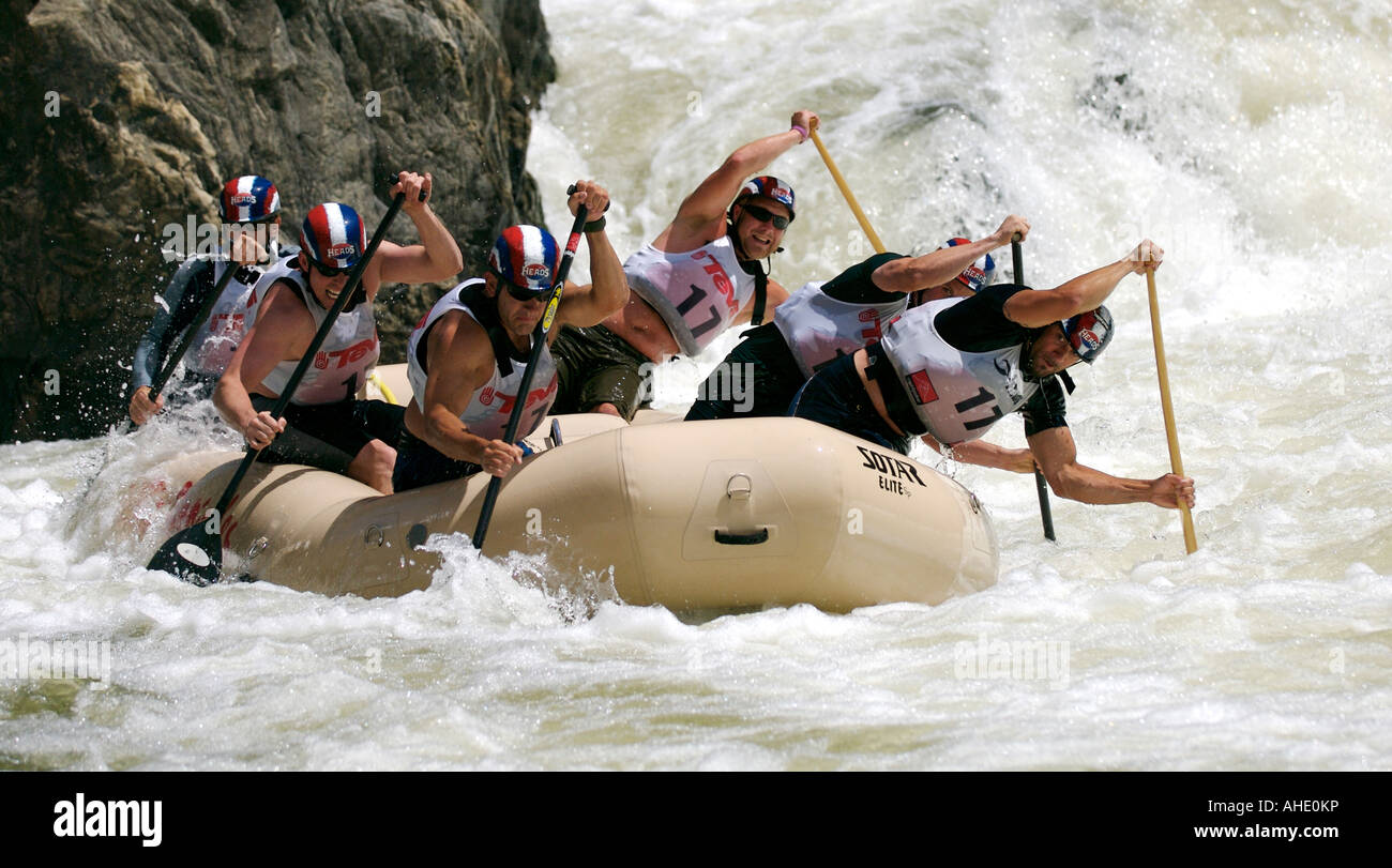 A team of men paddle a tan raft while competing in the 2006 Teva ...
