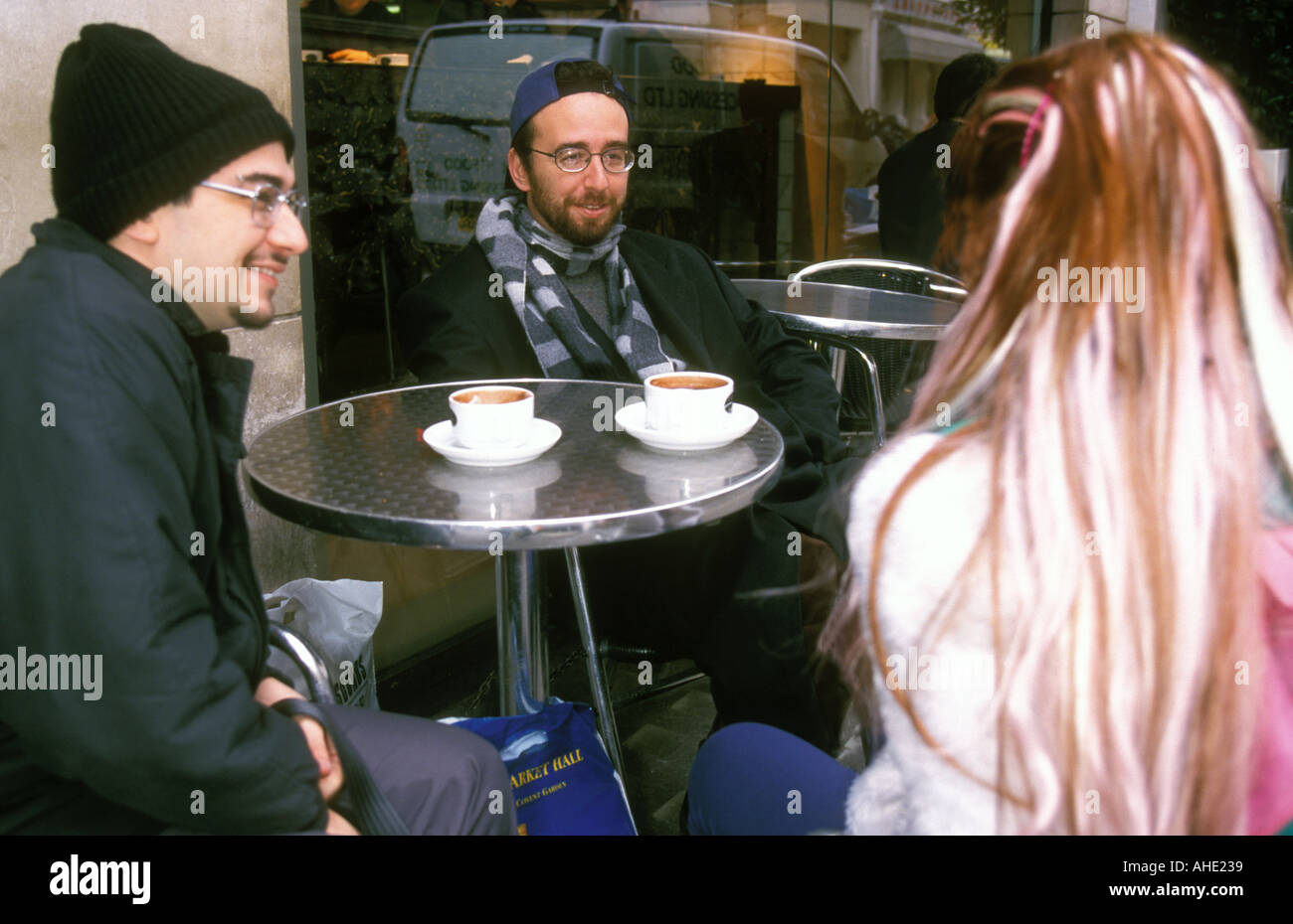 Young people having coffee in cafe on street pavement Stock Photo - Alamy