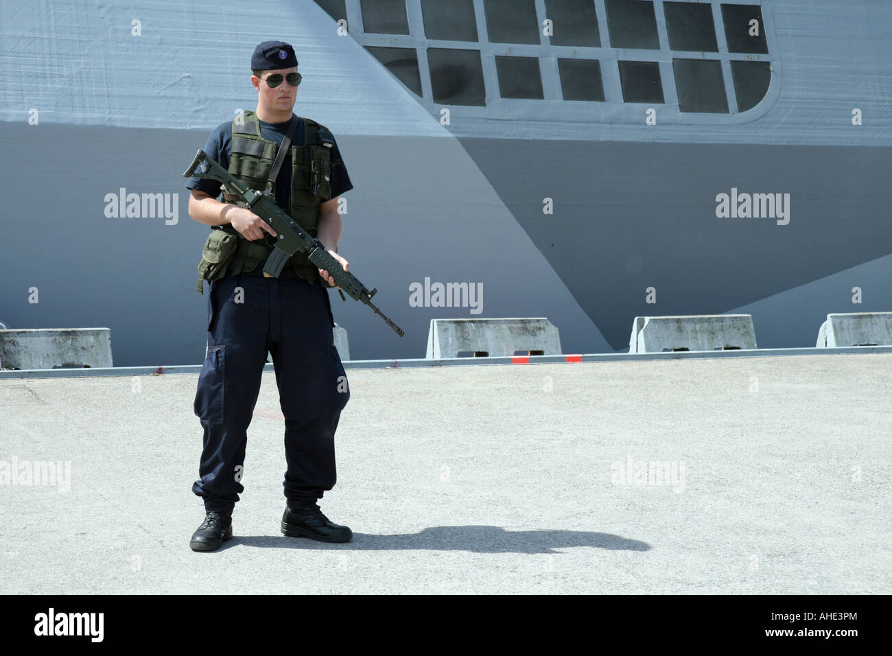 Swedish soldier guarding a Visby class stealth Corvette. This is K34 ...