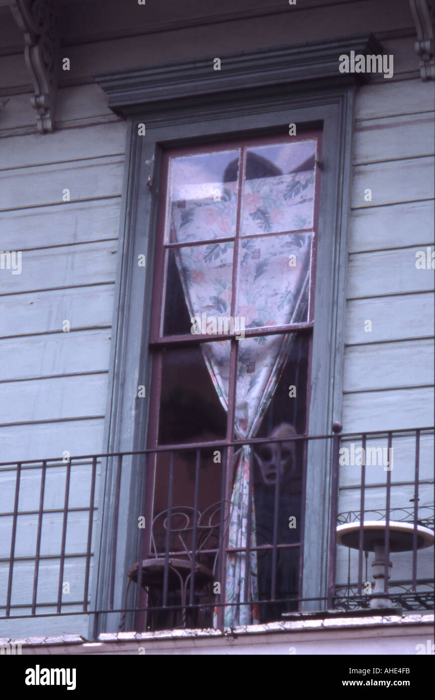 Ghostly figure reflected in window behind curtain New Orleans USA Stock ...