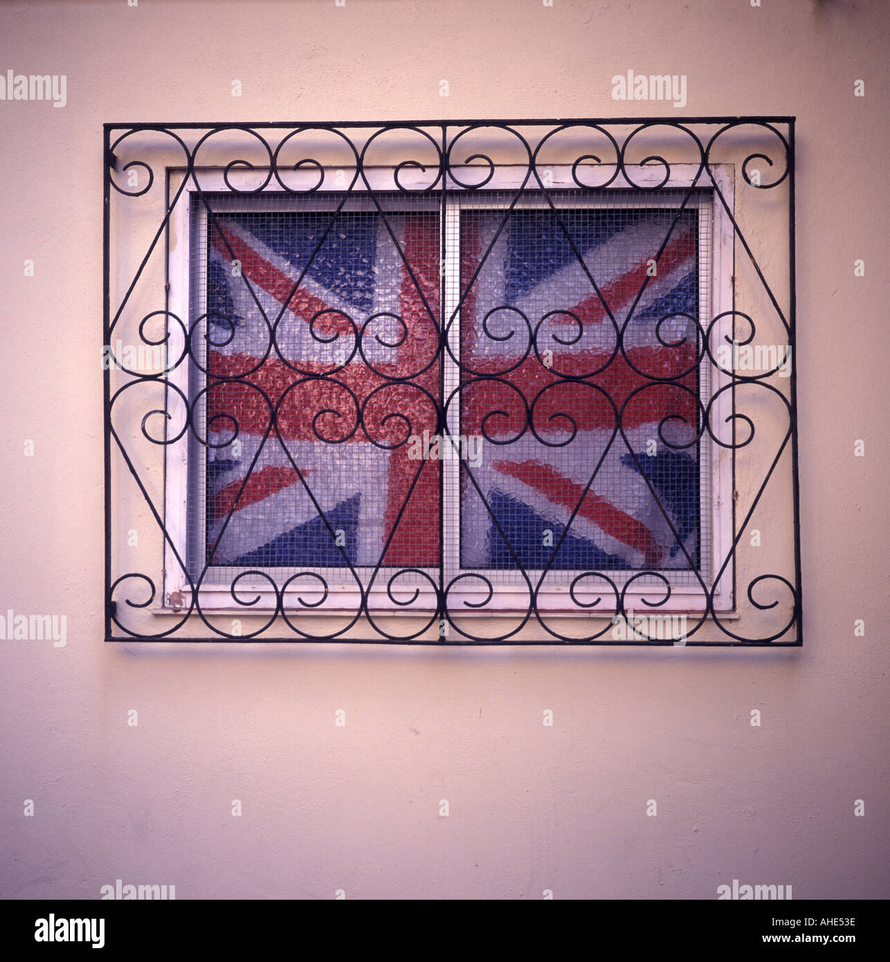 A union jack flag behind a kitchen window on a housing estate in ...