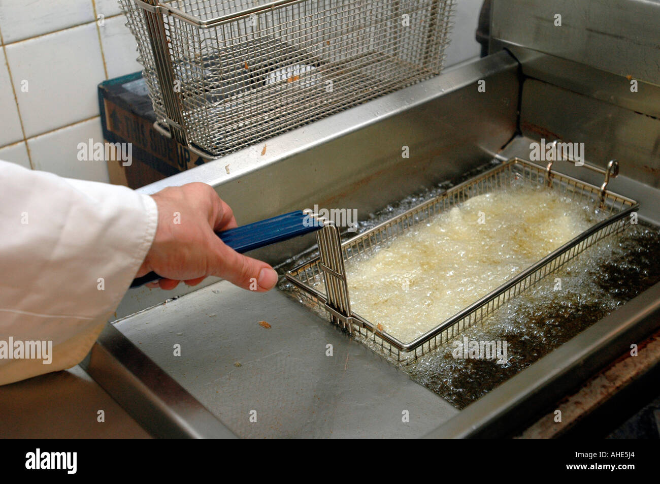 French fries being deep fried Stock Photo - Alamy