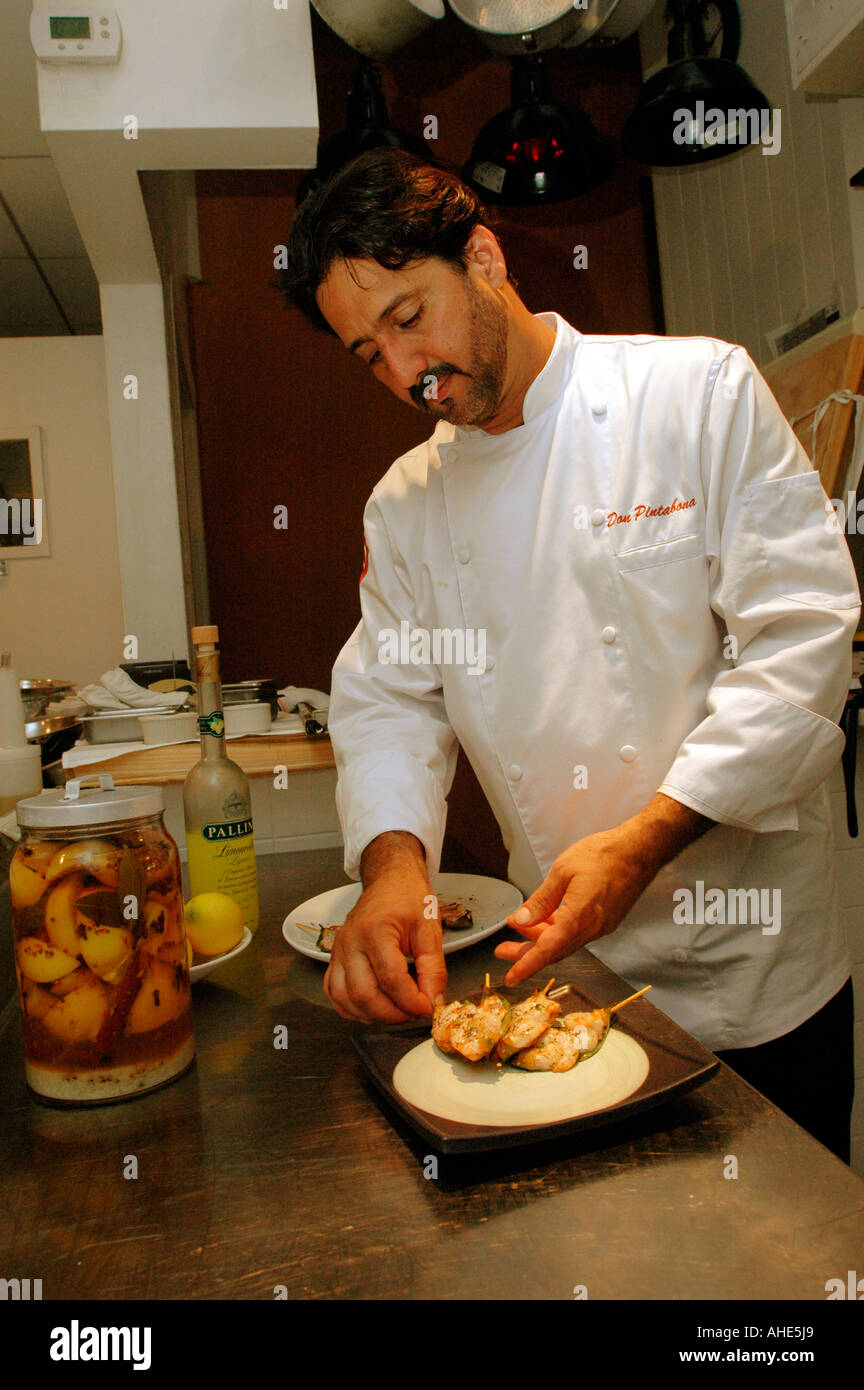 Chef prepares grilled shrimp on skewers with limoncello Stock Photo - Alamy
