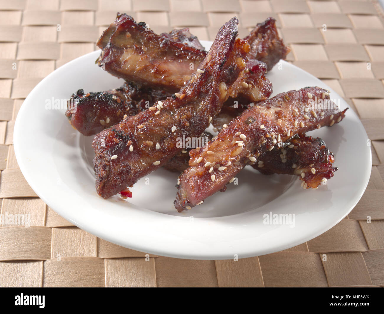 Sticky chinese pork spare ribs sesame seeds noodles hi-res stock ...