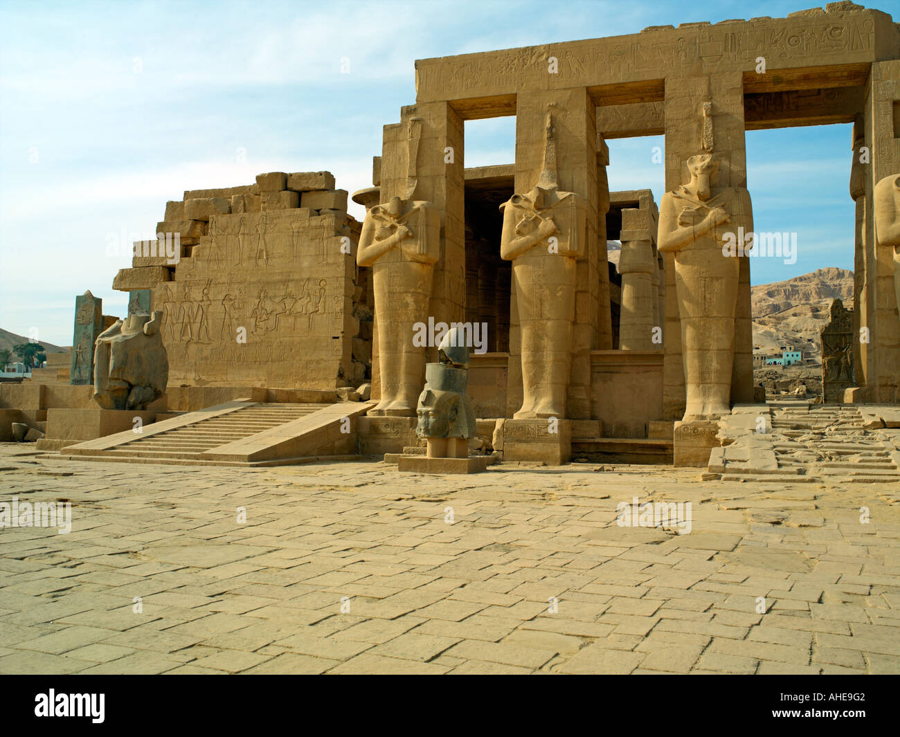 A fallen head of Ramses II with Osiris Pillars and a ramp to The ...