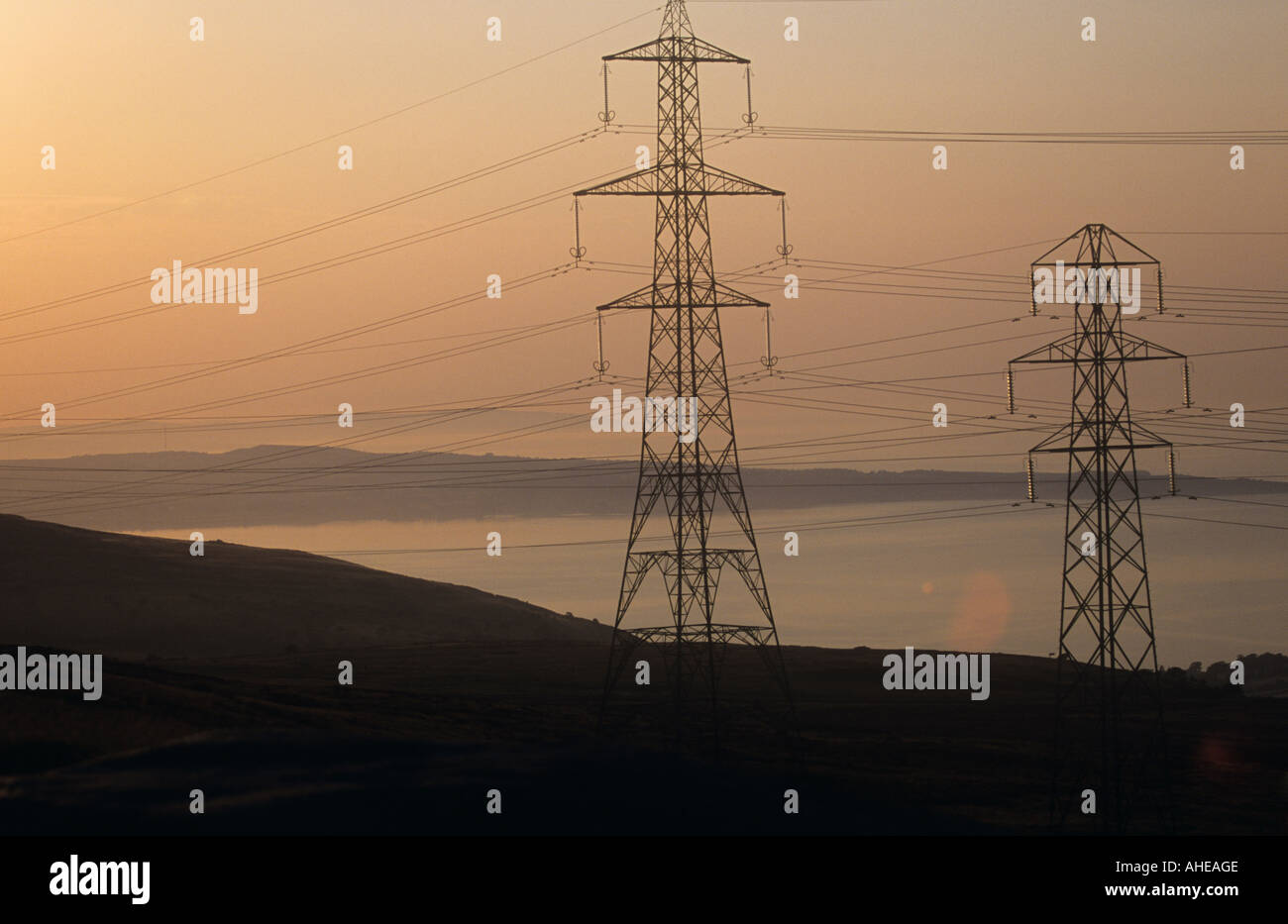Pylons with anglesey in the background Stock Photo - Alamy