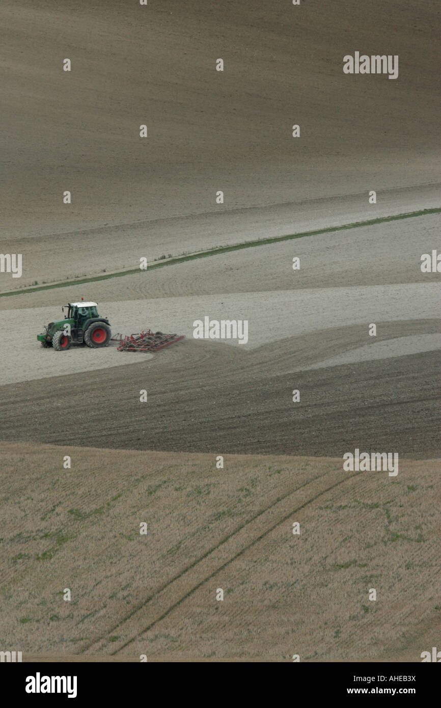 Tractor working in rolling countryside Stock Photo - Alamy