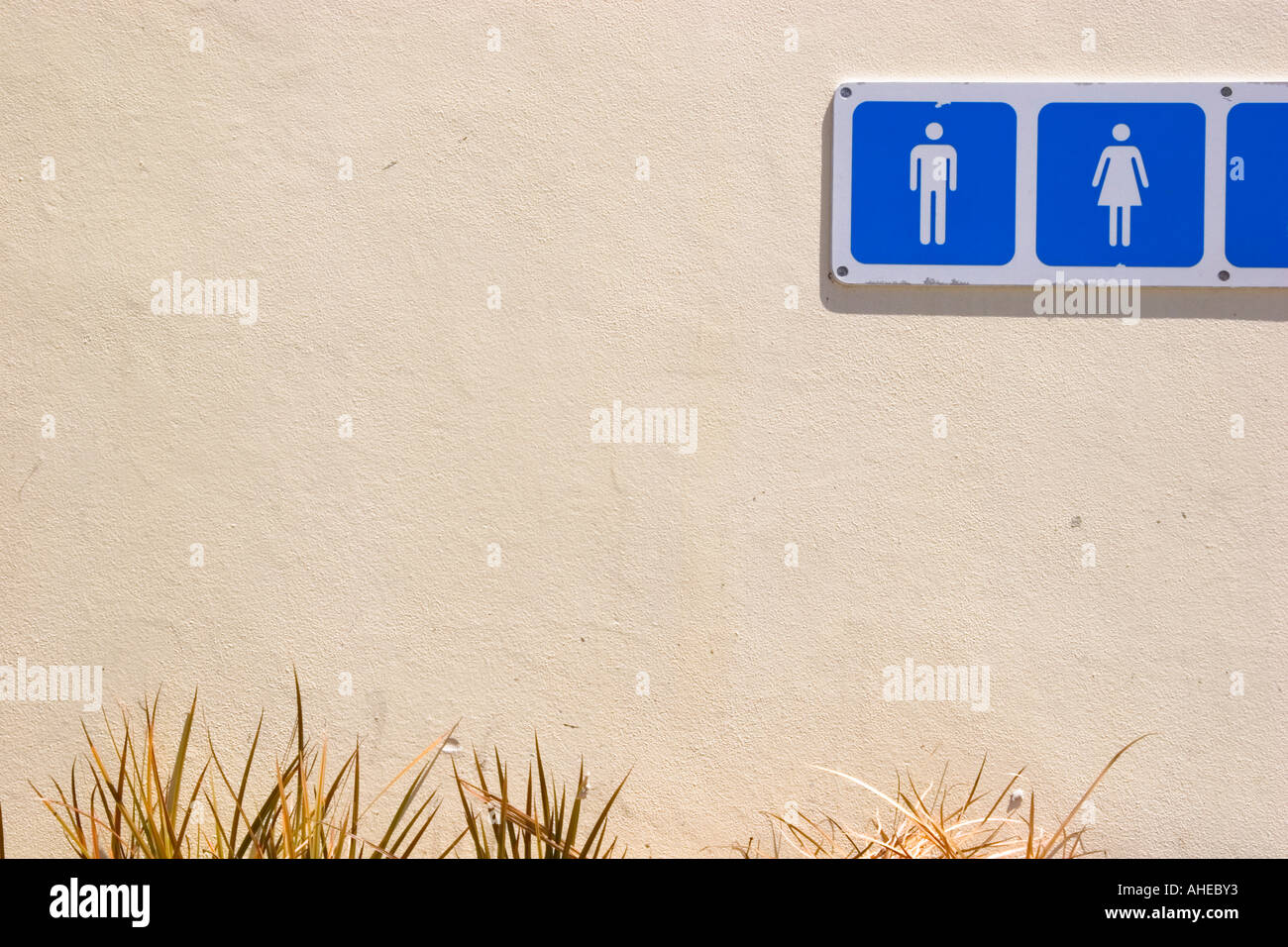 restroom signs with bushes Stock Photo - Alamy