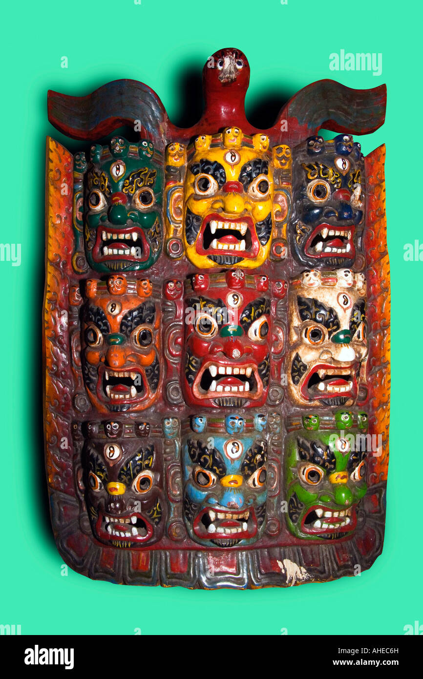 A carved and painted traditional wooden Bhutanese ceremonial shield ...