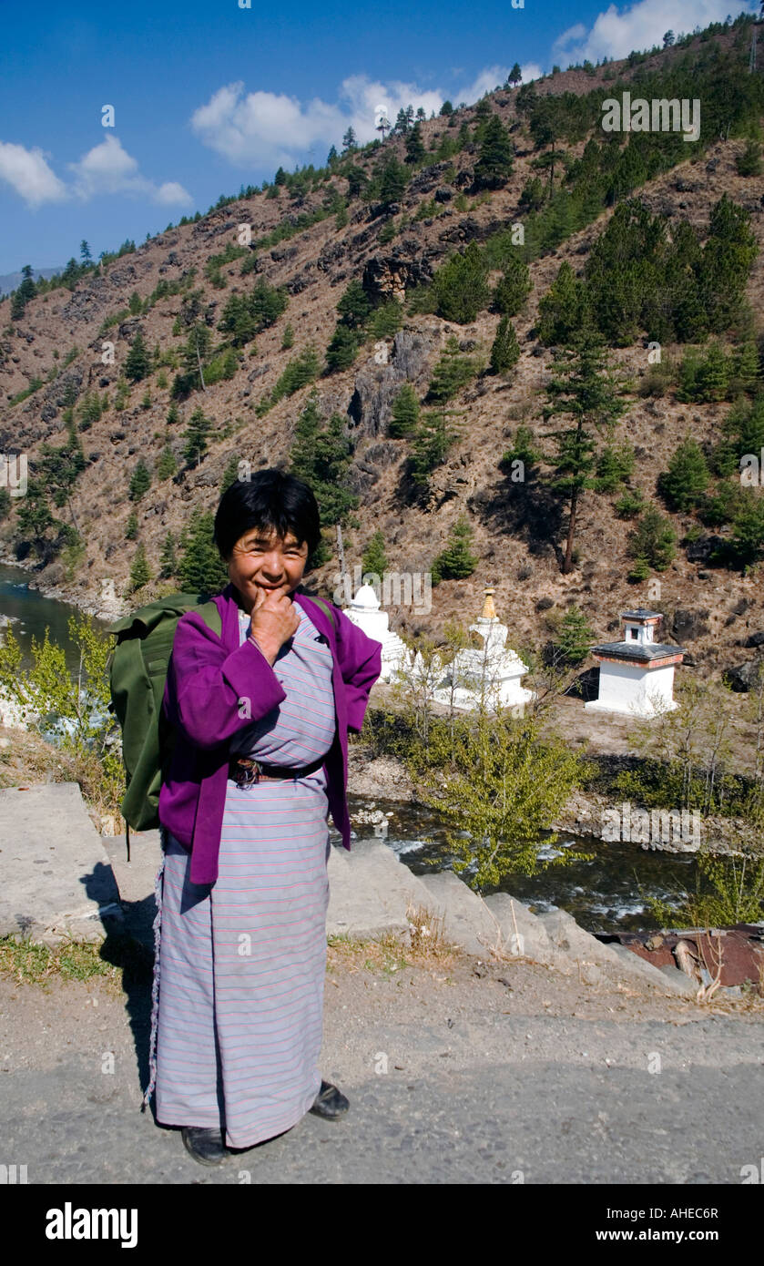 Bhutanese lady wearing a kira standing in front of the three main ...