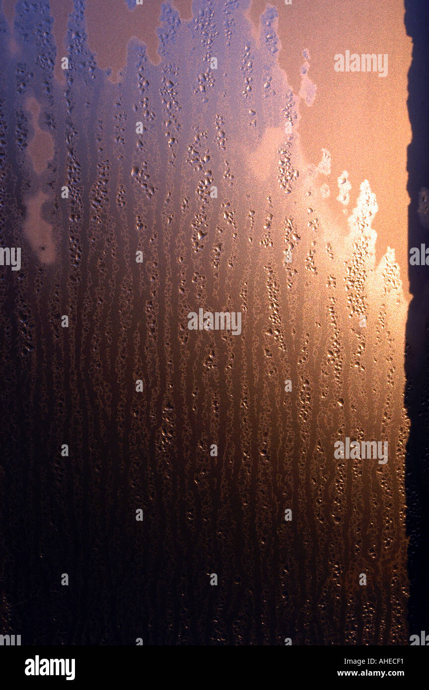 Sunrise through condensation covered window Stock Photo - Alamy