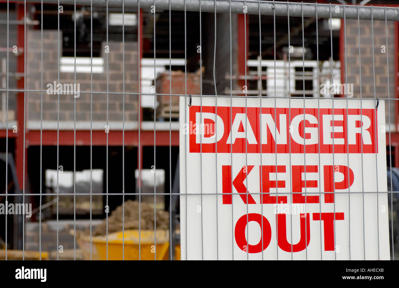 DANGER KEEP OUT sign fastened to wire fencing on building site Stock ...