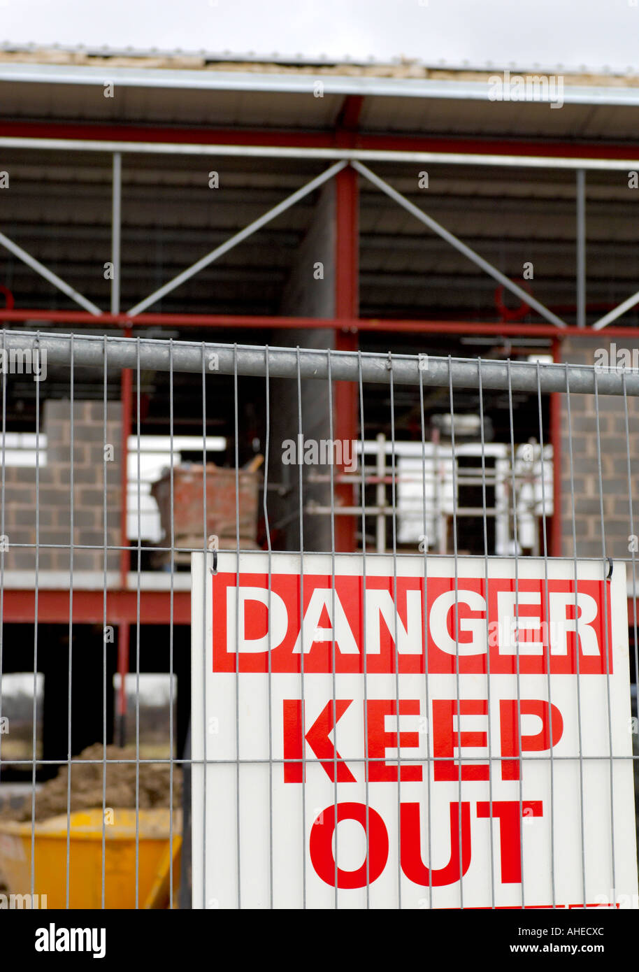 DANGER KEEP OUT sign fastened to wire fencing on building site Stock ...