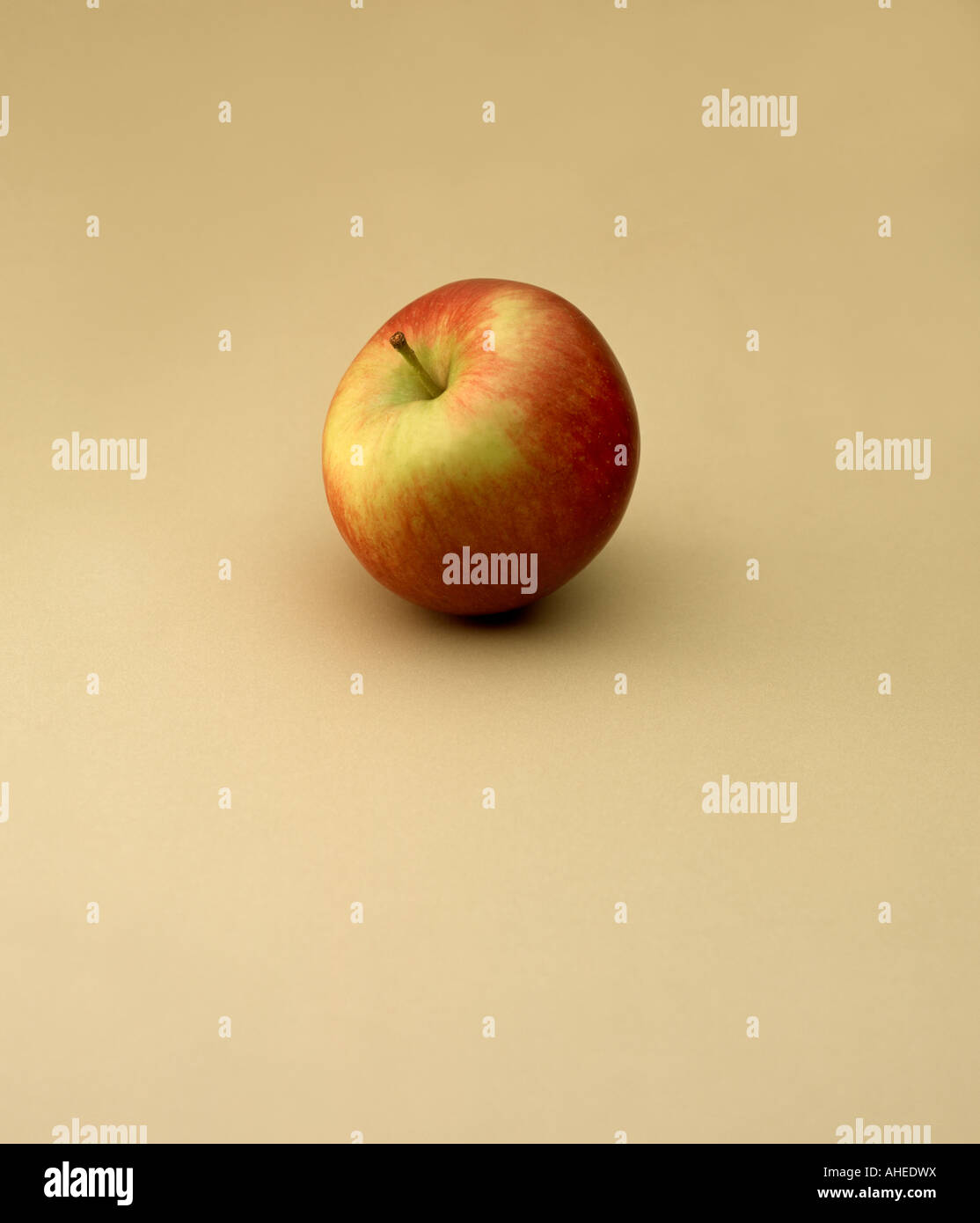 Red apple on beige background Stock Photo - Alamy