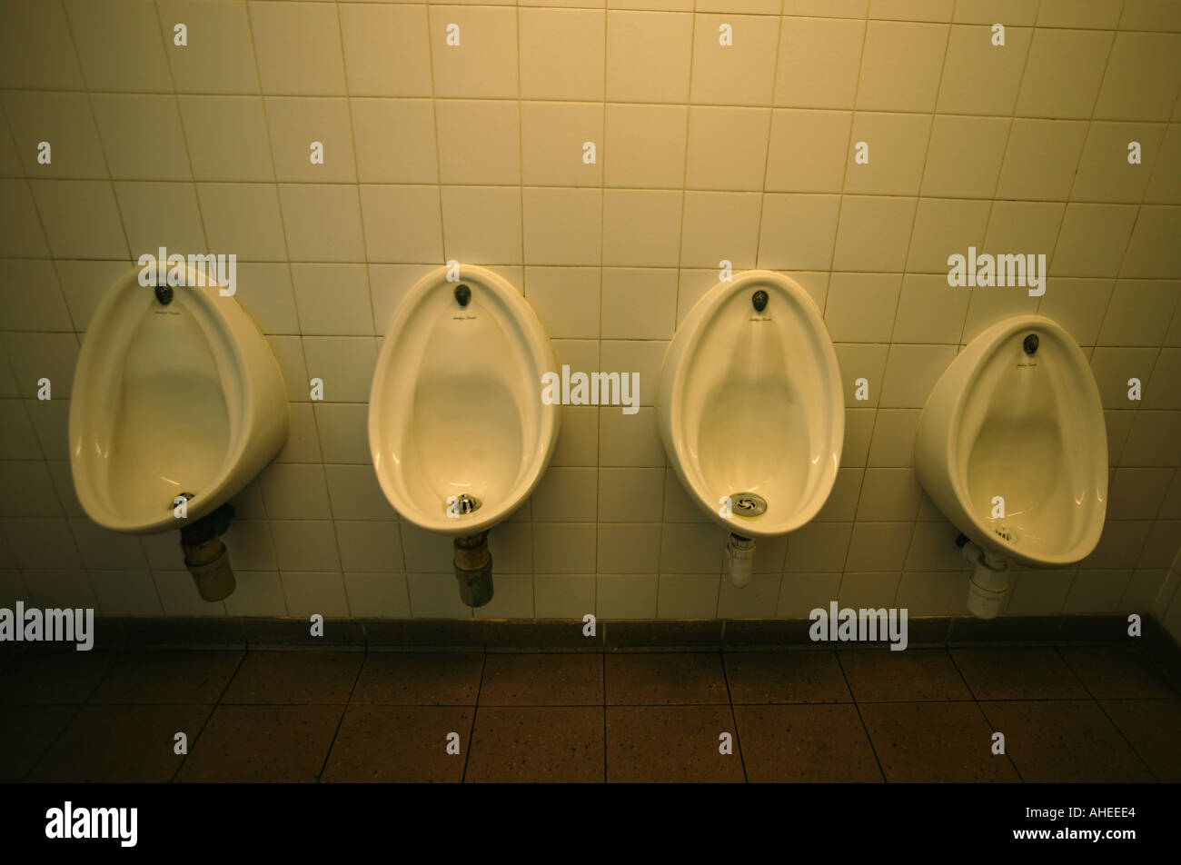 urinals 4 in a row in a gents toilet Stock Photo - Alamy