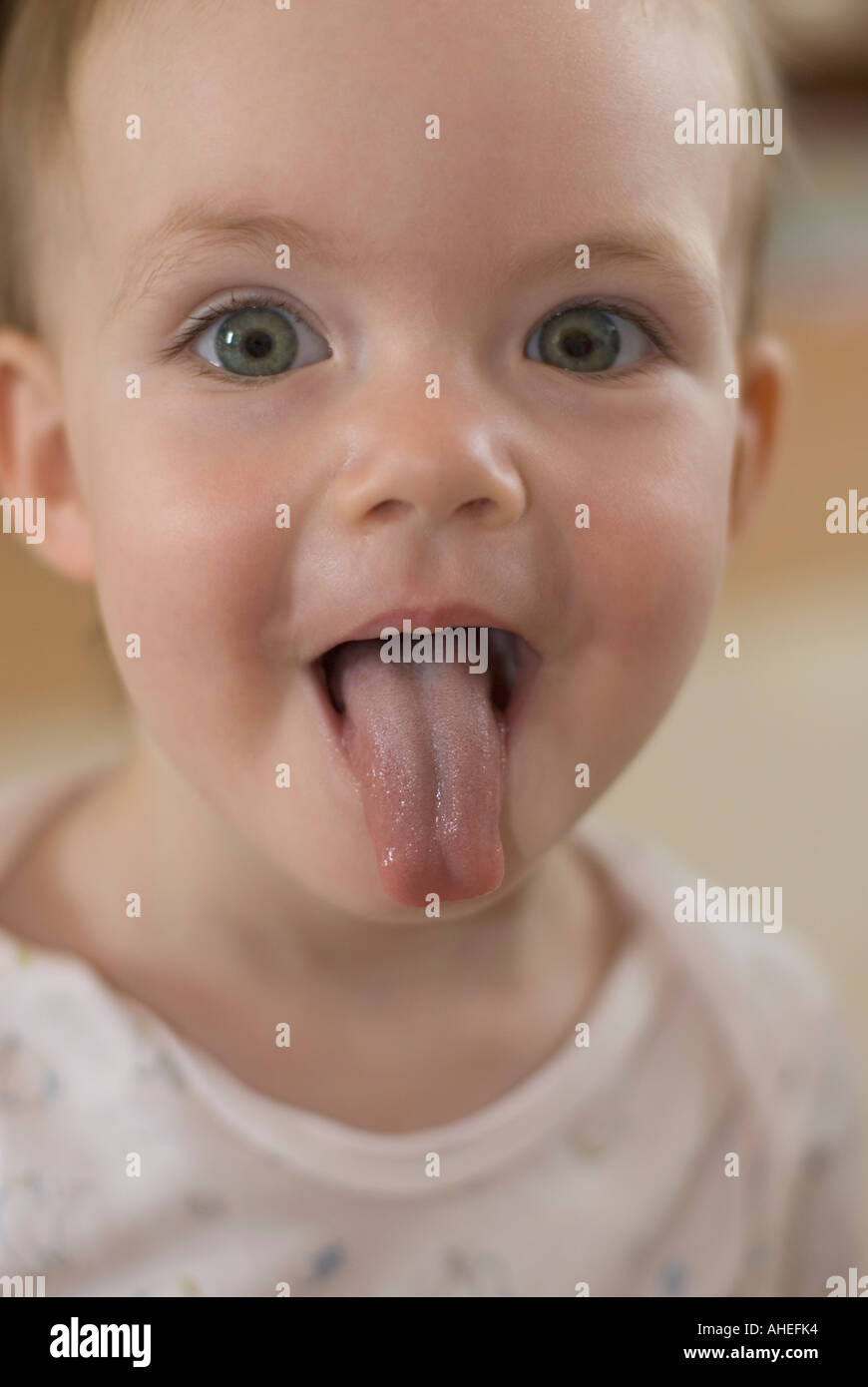 Little child putting out tongue Stock Photo - Alamy