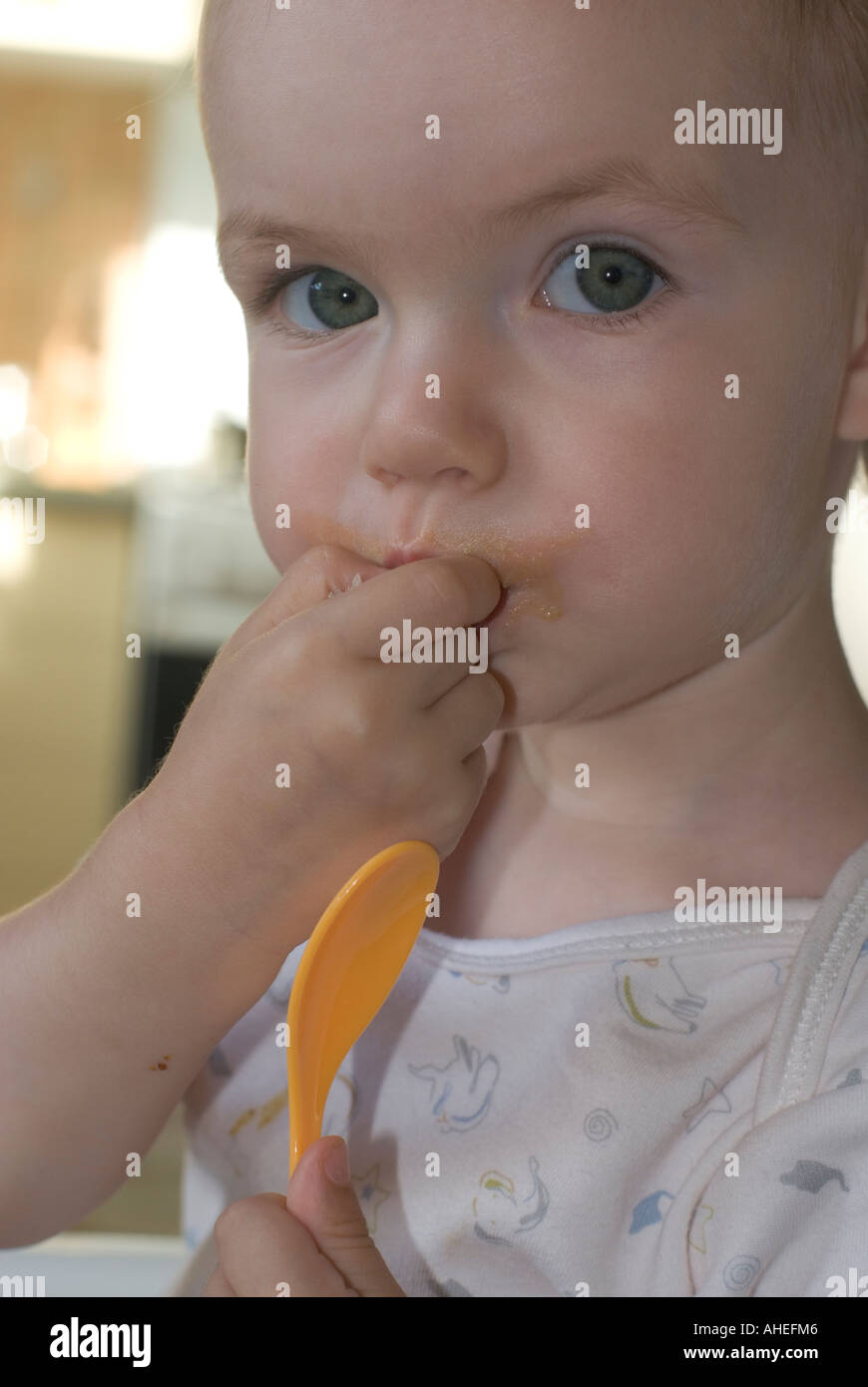 Little child eating in kitchen Stock Photo - Alamy