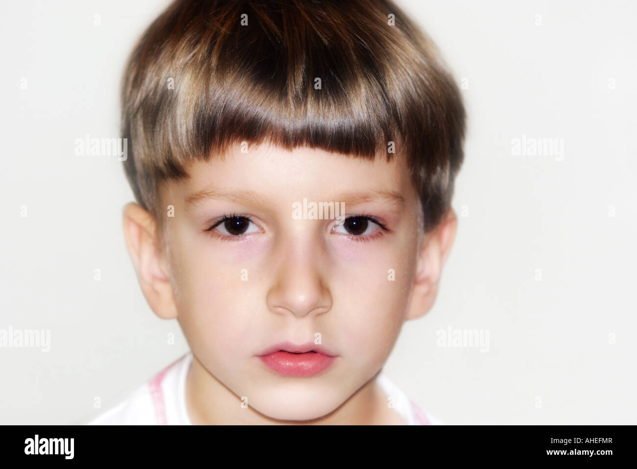 kid posing with serious look Focus on face and blured from site to give ...